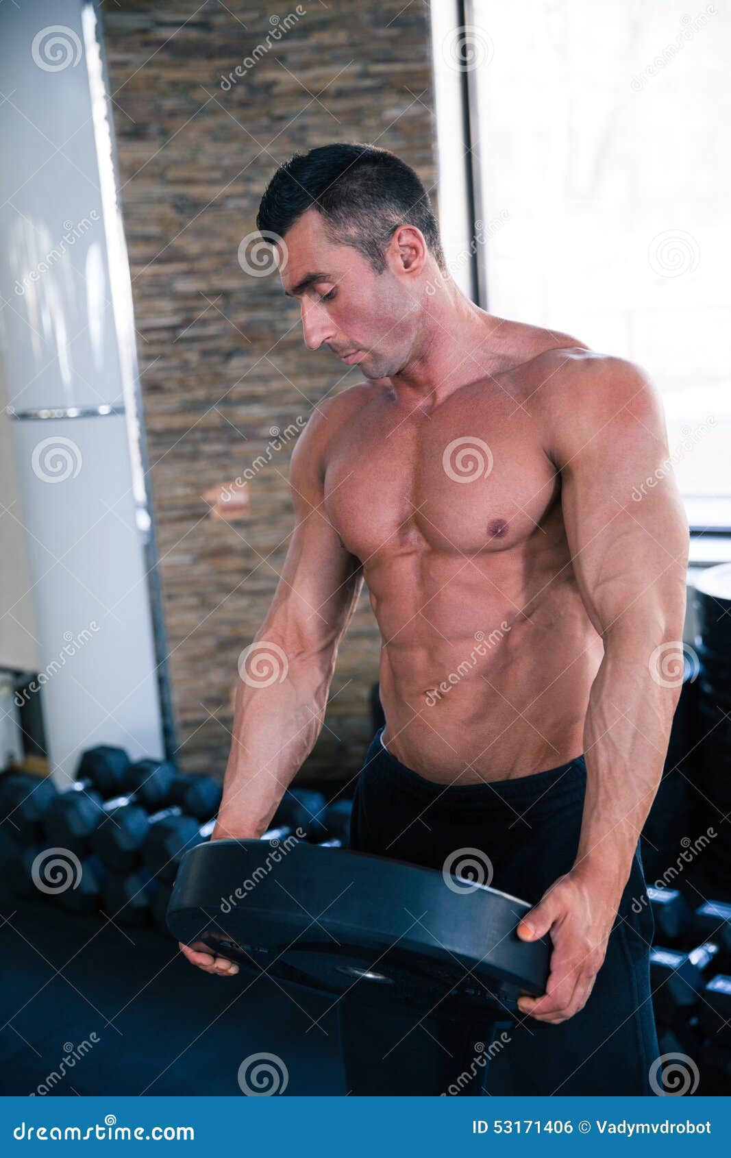 Muscular Man Holding Weight Stock Photo - Image of male, round: 53171406