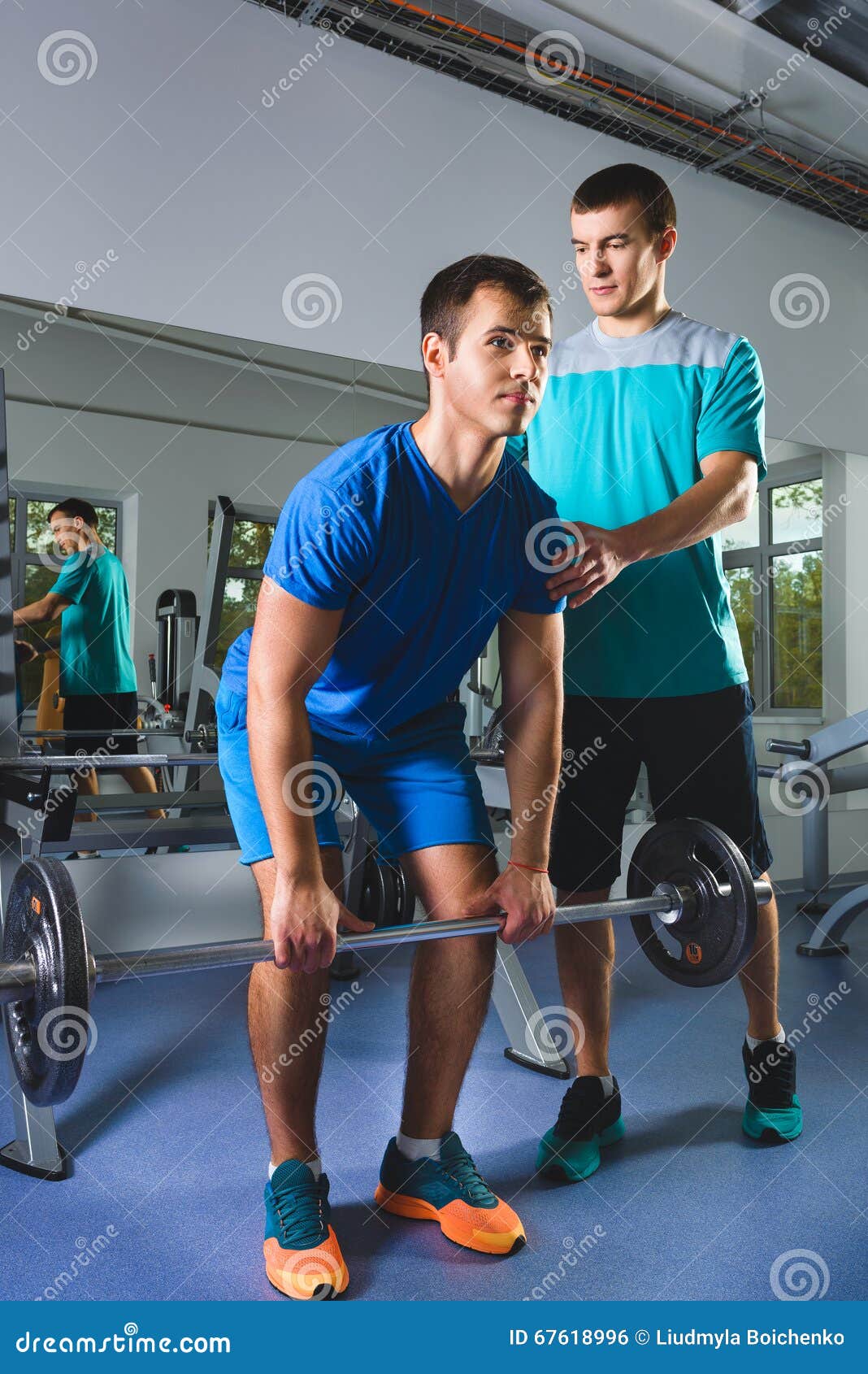 Muscular Man Lifting Deadlift in the Gym with Instructor Stock Photo ...