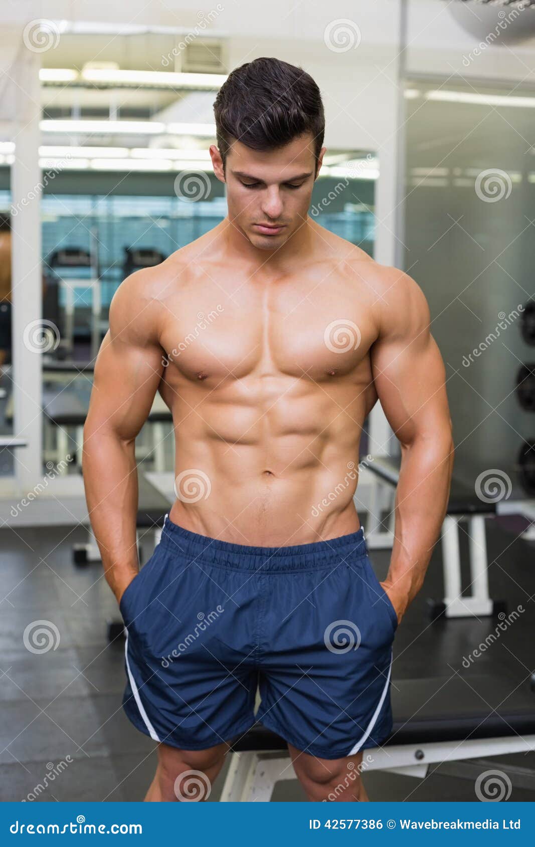 Muscular man looking down stock photo. Image of toned - 42577386