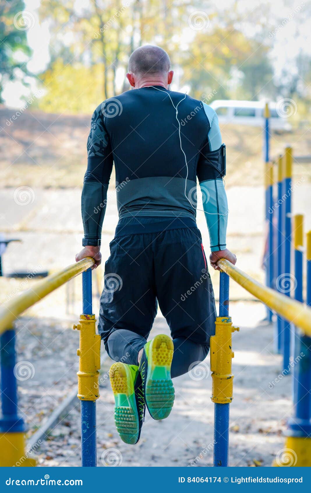 Muscular Man on Parallel Bars Stock Photo - Image of lifting, outside ...