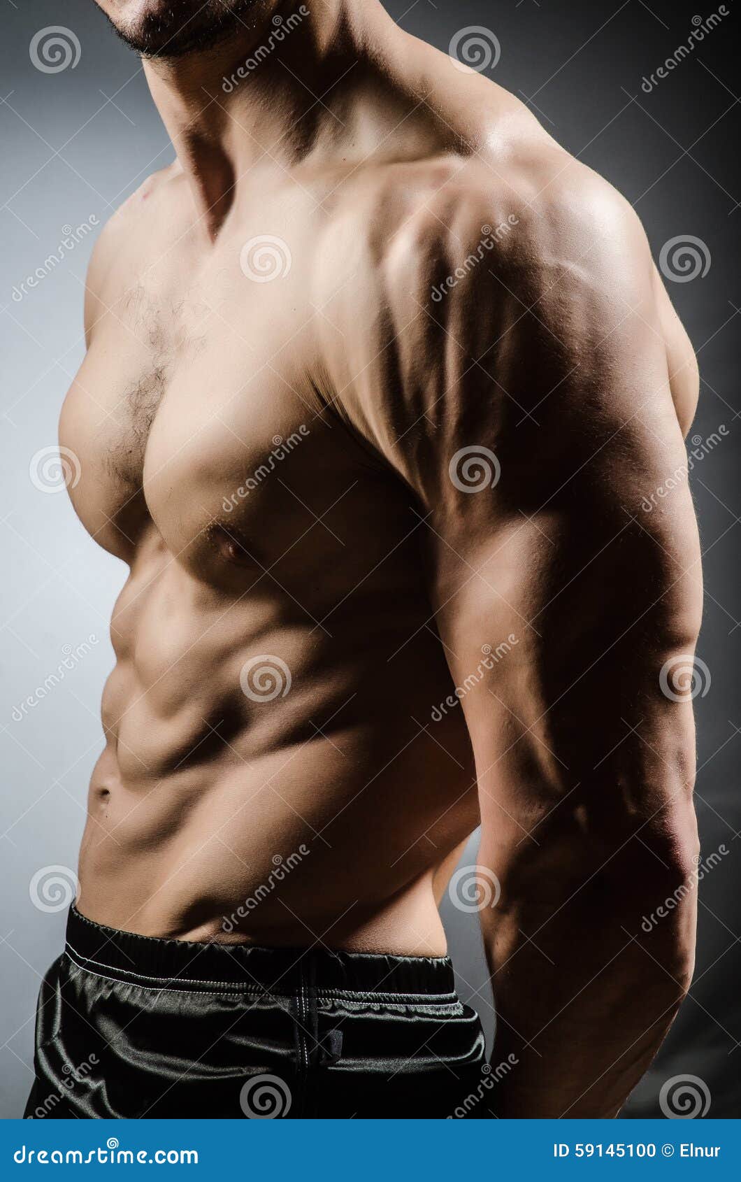 Muscular Man Posing in Dark Studio Stock Photo - Image of biceps ...