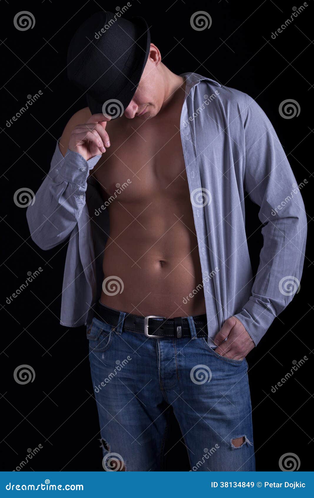 A Muscular Man Posing with Hat,on Black Background Stock Image - Image ...