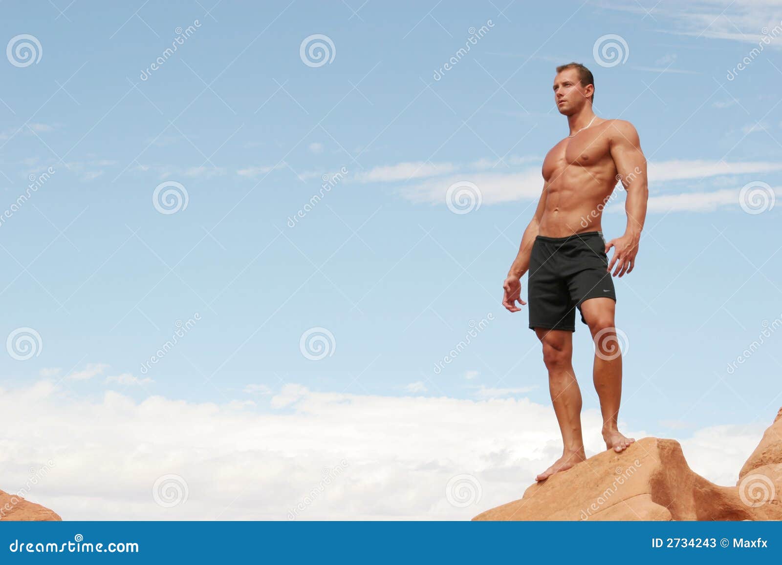 Muscular man on red rocks stock image. Image of abdomen - 2734243