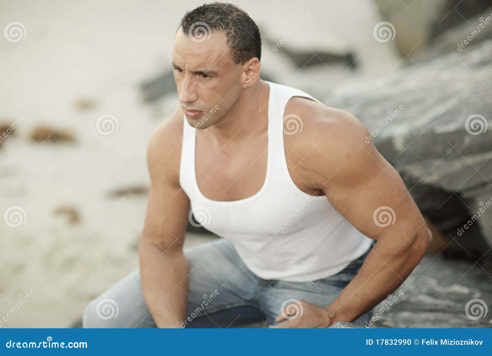Muscular man on the rocks stock photo. Image of horizontal - 17832990