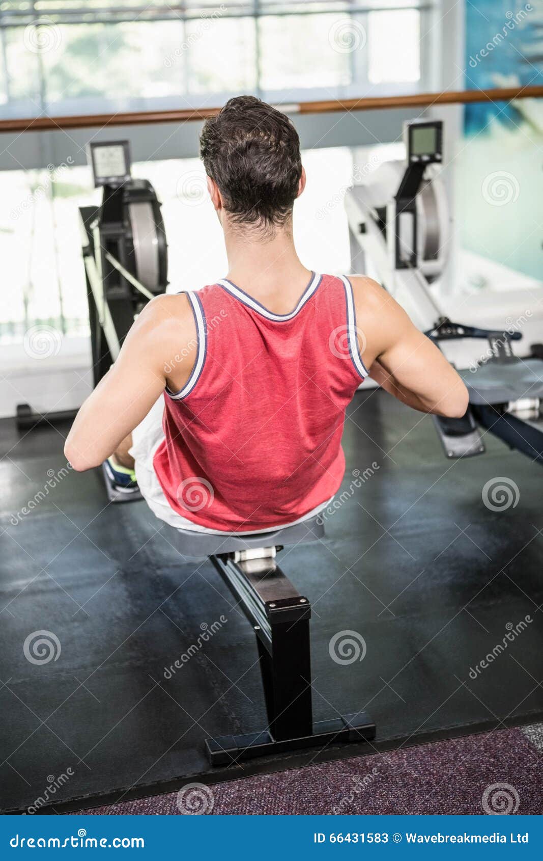 Muscular Man on Rowing Machine Stock Image - Image of studio, lifestyle ...