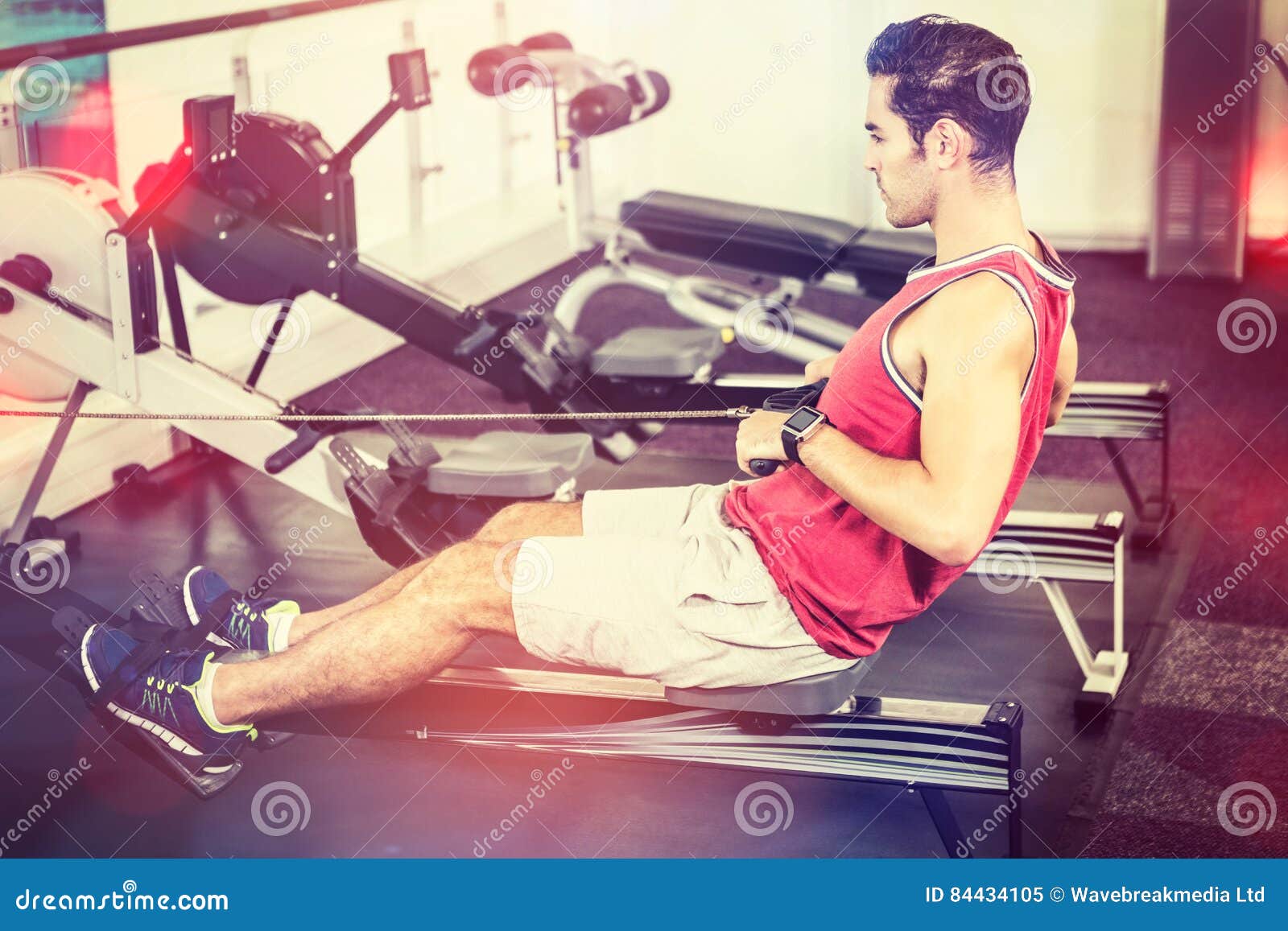 Muscular Man on Rowing Machine Stock Image - Image of leisure, healthy ...