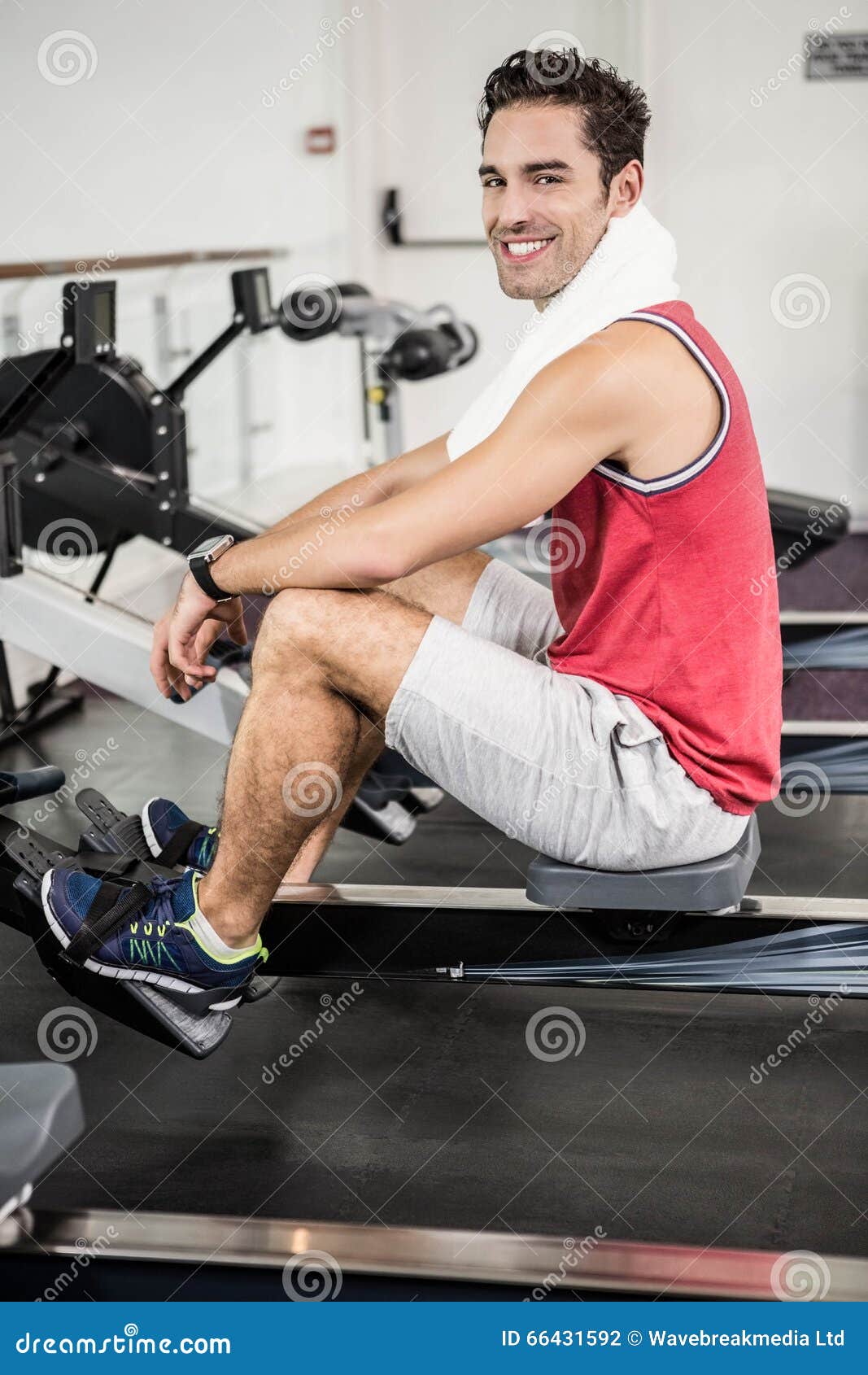 Muscular Man on Rowing Machine Smiling at the Camera Stock Photo ...