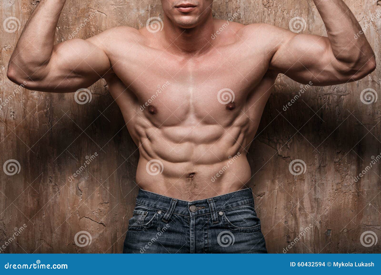 Muscular Man Showing Abs, on Wall Background Stock Photo - Image of ...