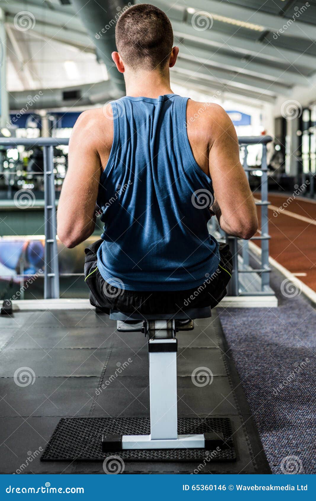 Muscular Man Using Rowing Machine Stock Photo - Image of rowing, sports ...
