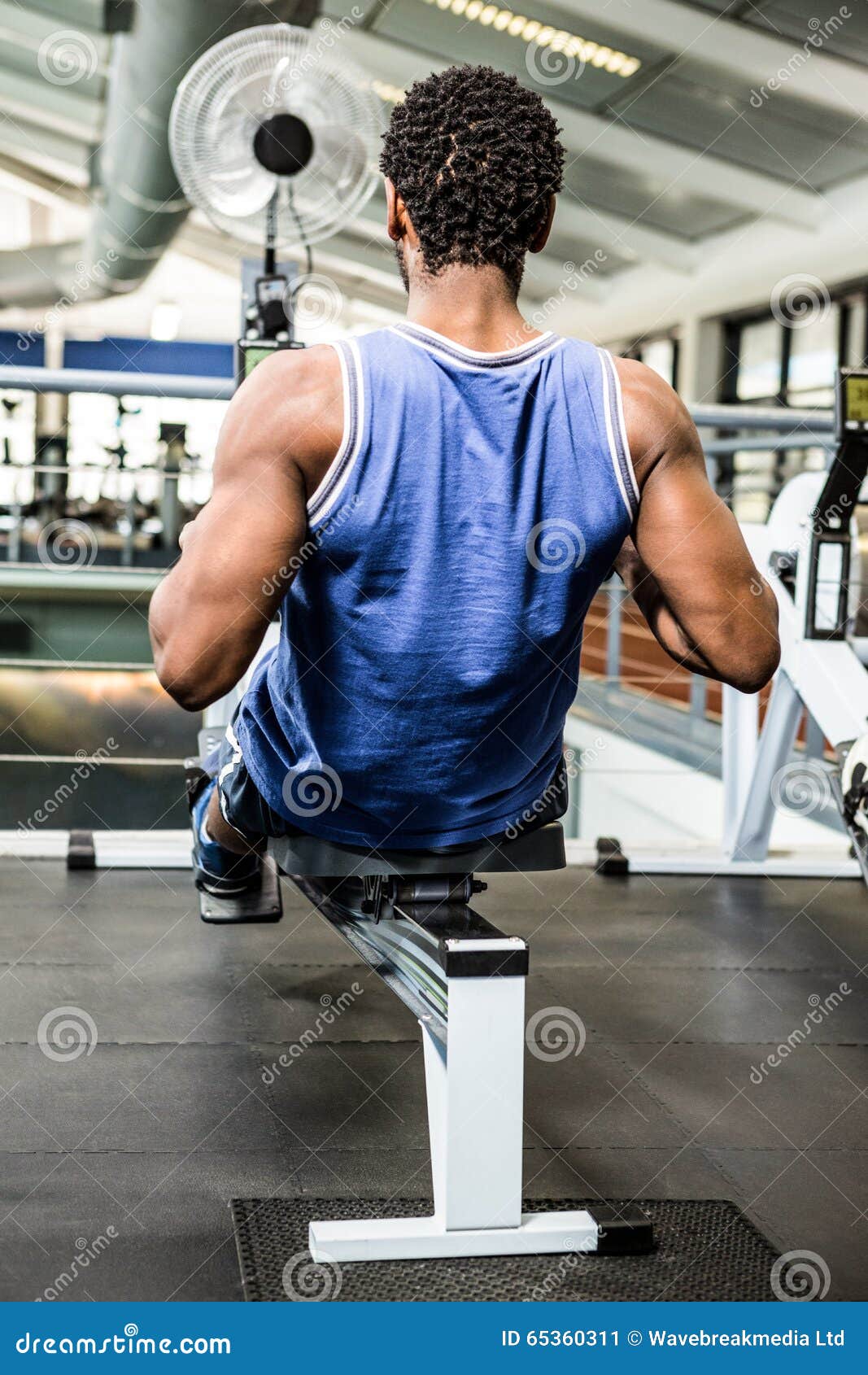 Muscular Man Using Rowing Machine Stock Image - Image of active ...