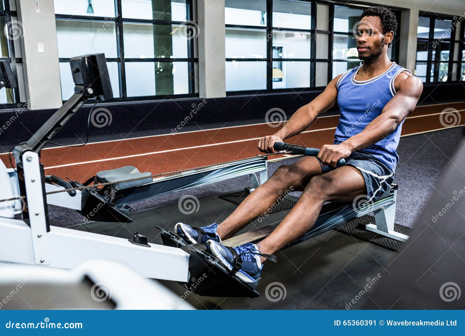 Muscular Man Using Rowing Machine Stock Image - Image of healthy, grey ...