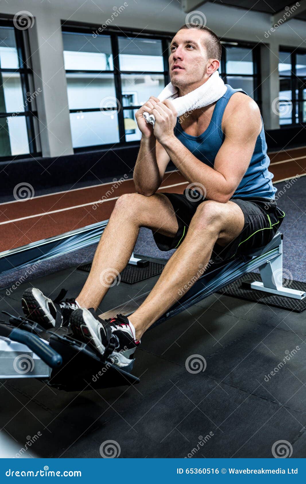 Muscular Man Using Rowing Machine Stock Photo - Image of athletic ...