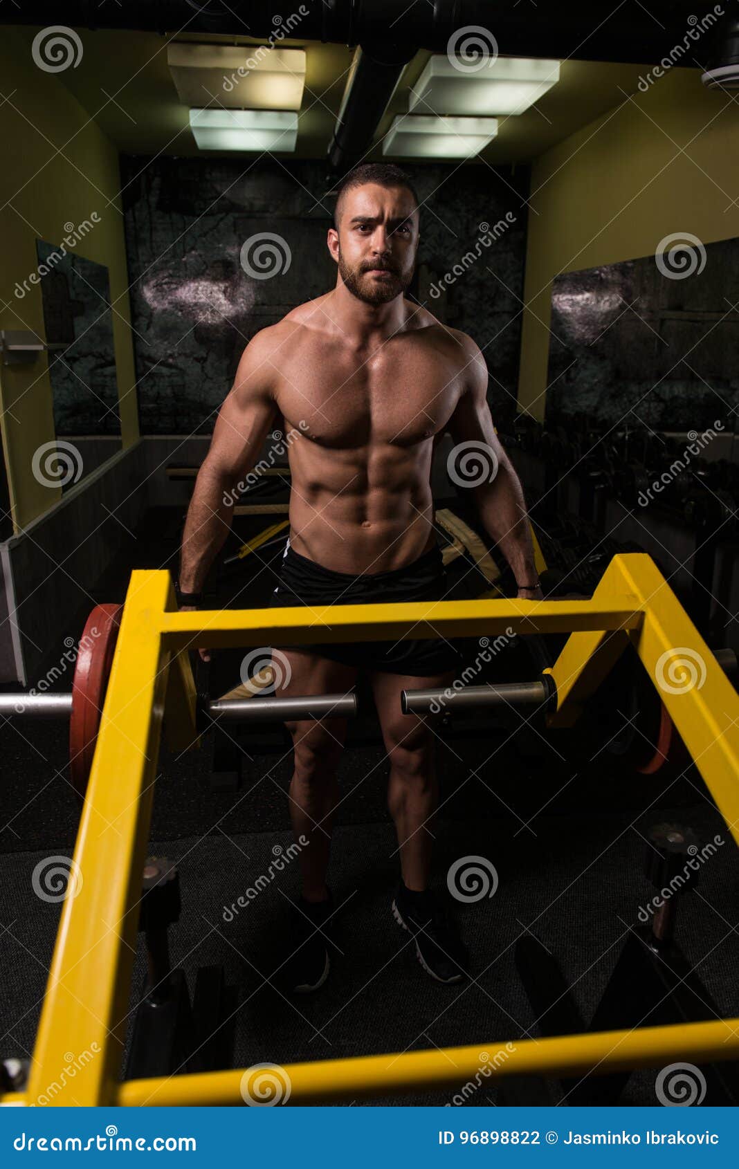 Muscular Model Doing Heavy Weight Exercise for Trapezius Stock Photo ...