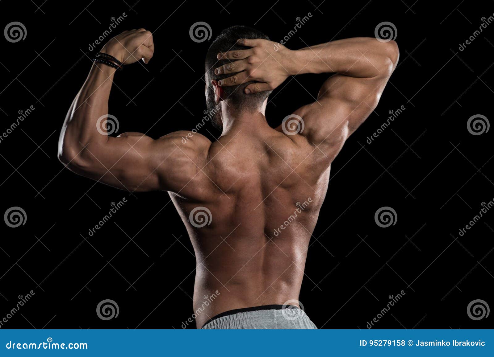 Muscular Model Flexing Muscles on Black Background Stock Photo - Image ...