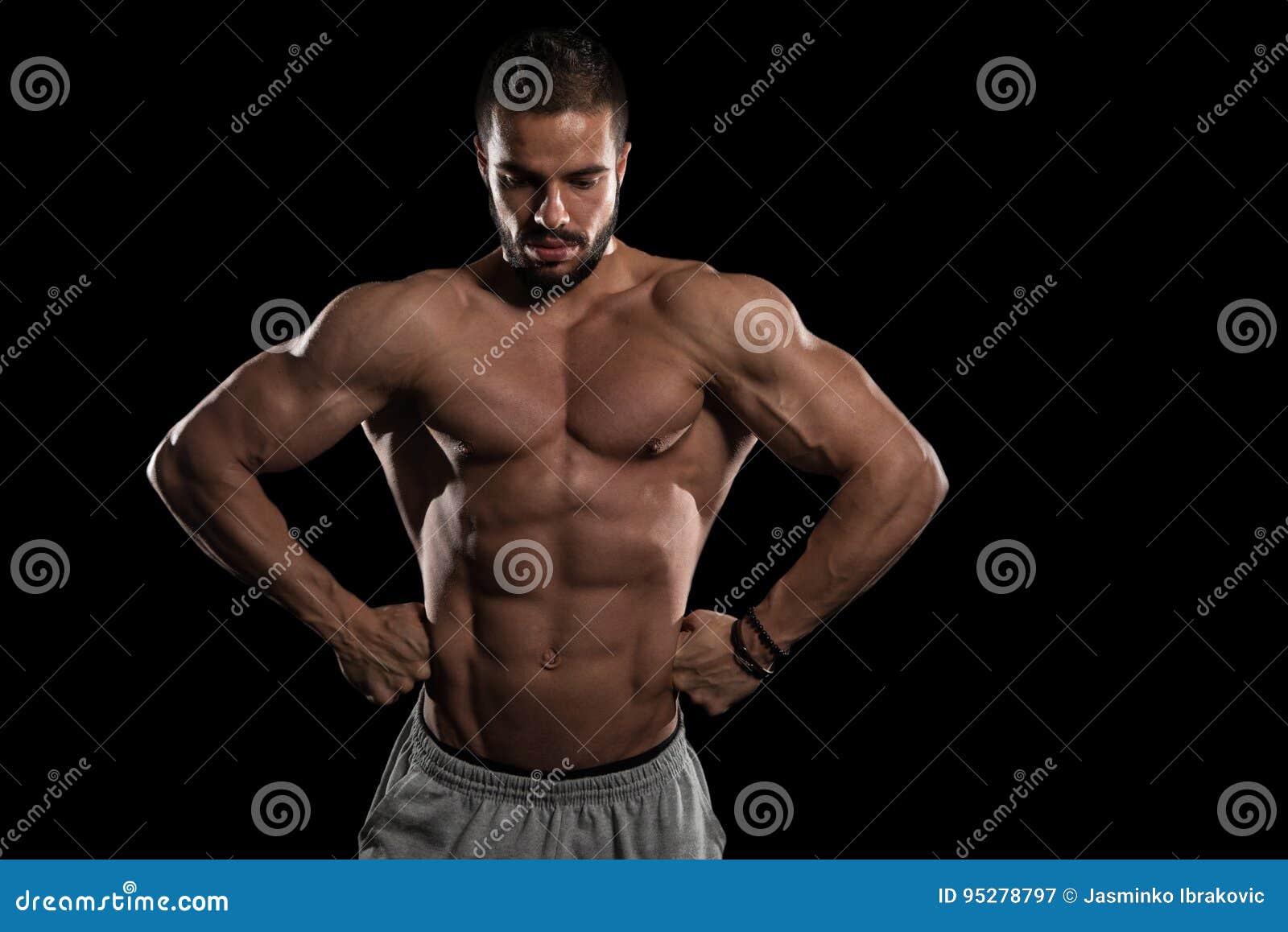 Muscular Model Flexing Muscles on Black Background Stock Image - Image ...