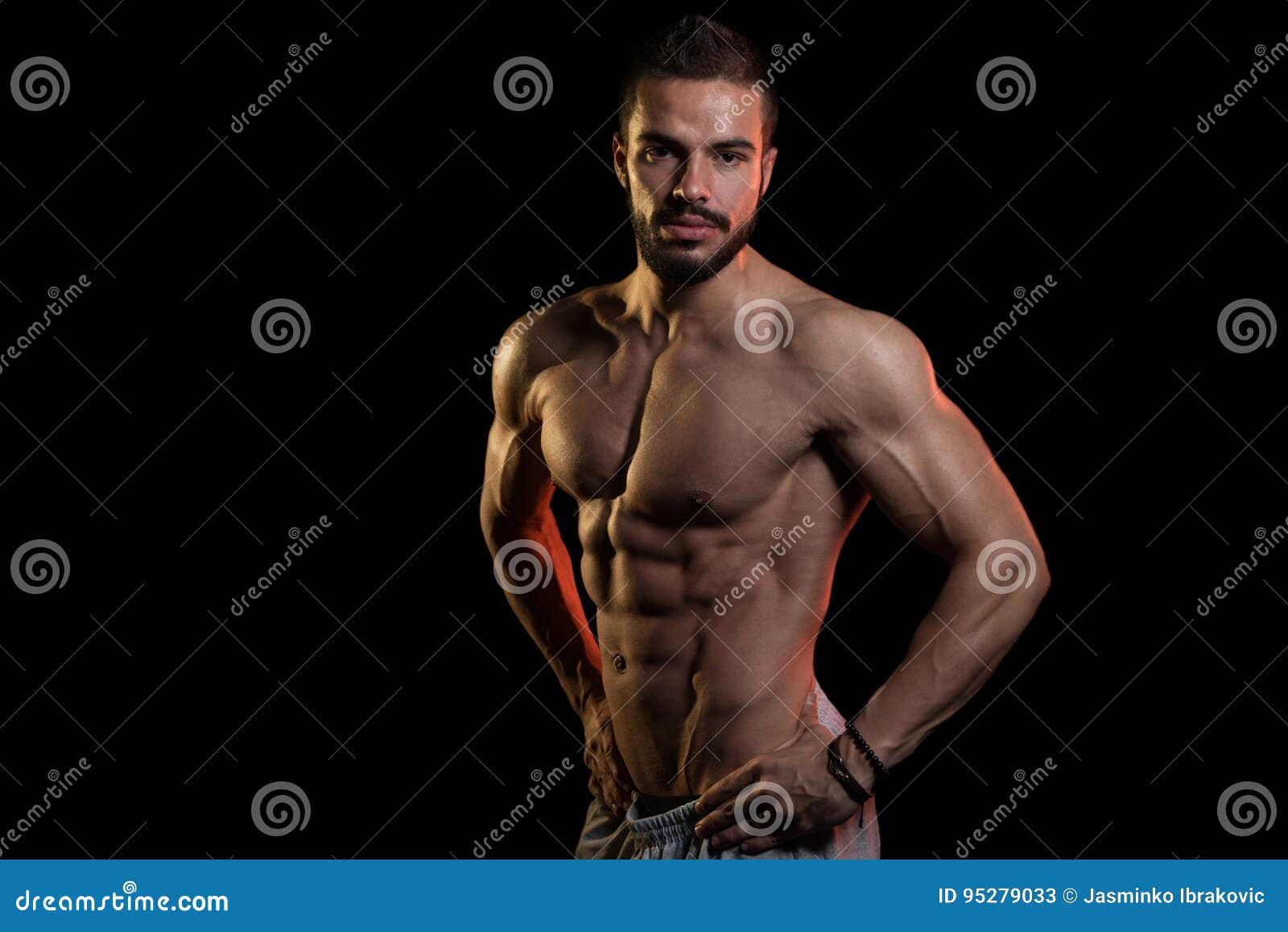 Muscular Model Flexing Muscles on Black Background Stock Image - Image ...