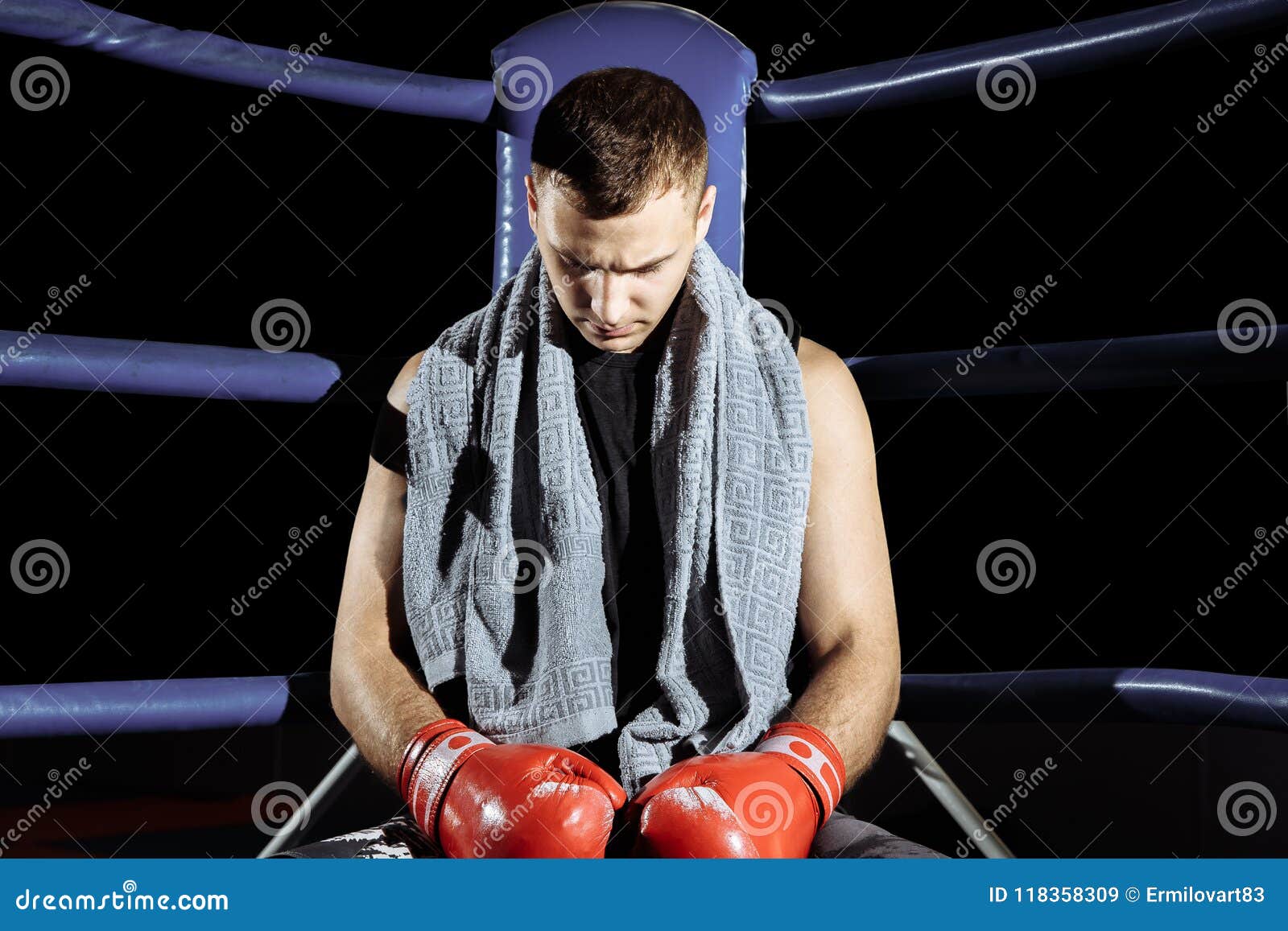 Muscular Professional Kick Boxer Resting on the Ropes in the Corner of ...