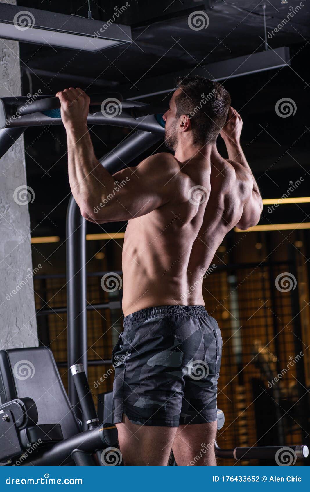 Muscular Young Man Doing Exercise for the Back on Horizontal Bar Stock ...