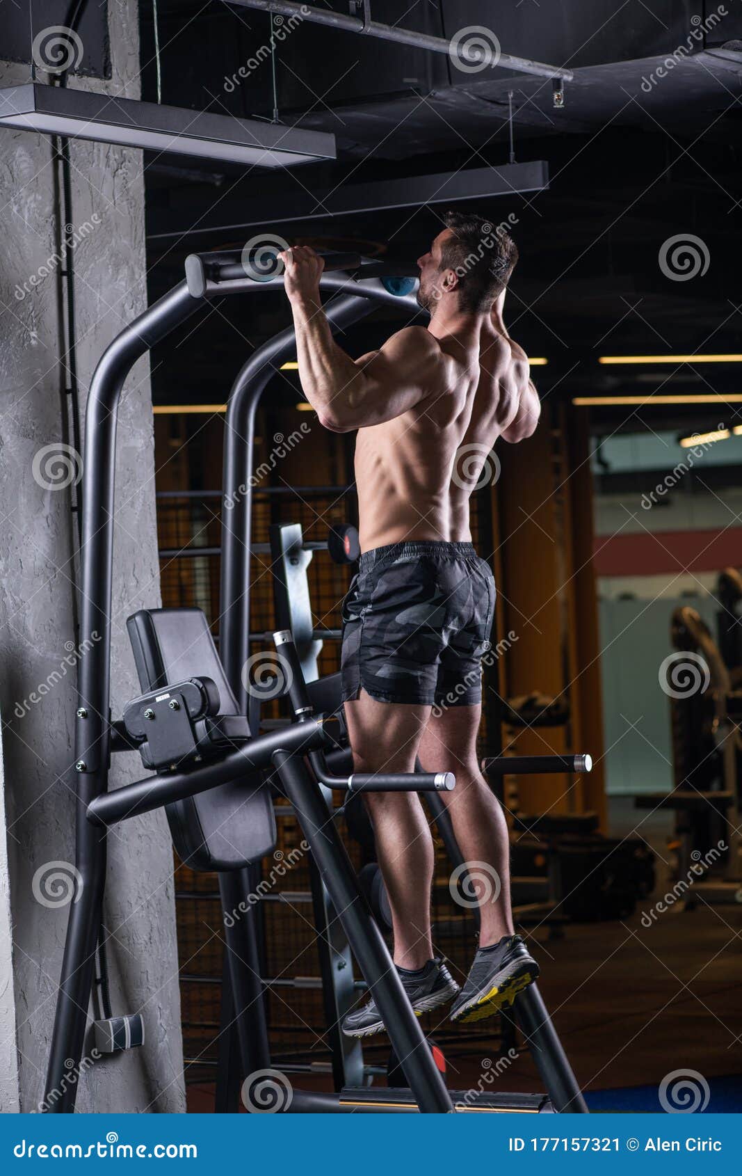 Muscular Young Man Doing Exercise for the Back on Horizontal Bar Stock ...