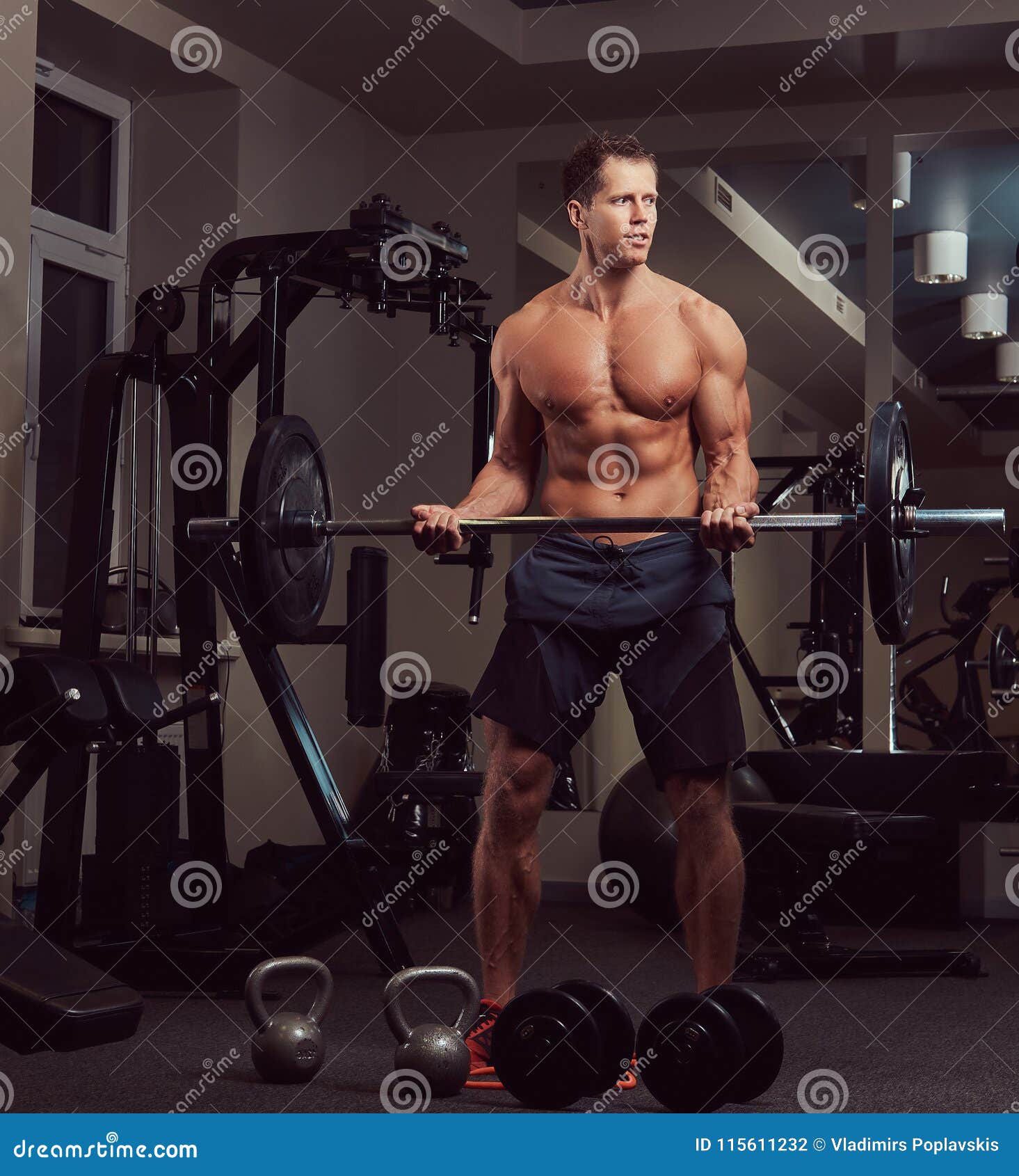 Muscular Shirtless Bodybuilder Male Lifting A Barbell On A Biceps In A