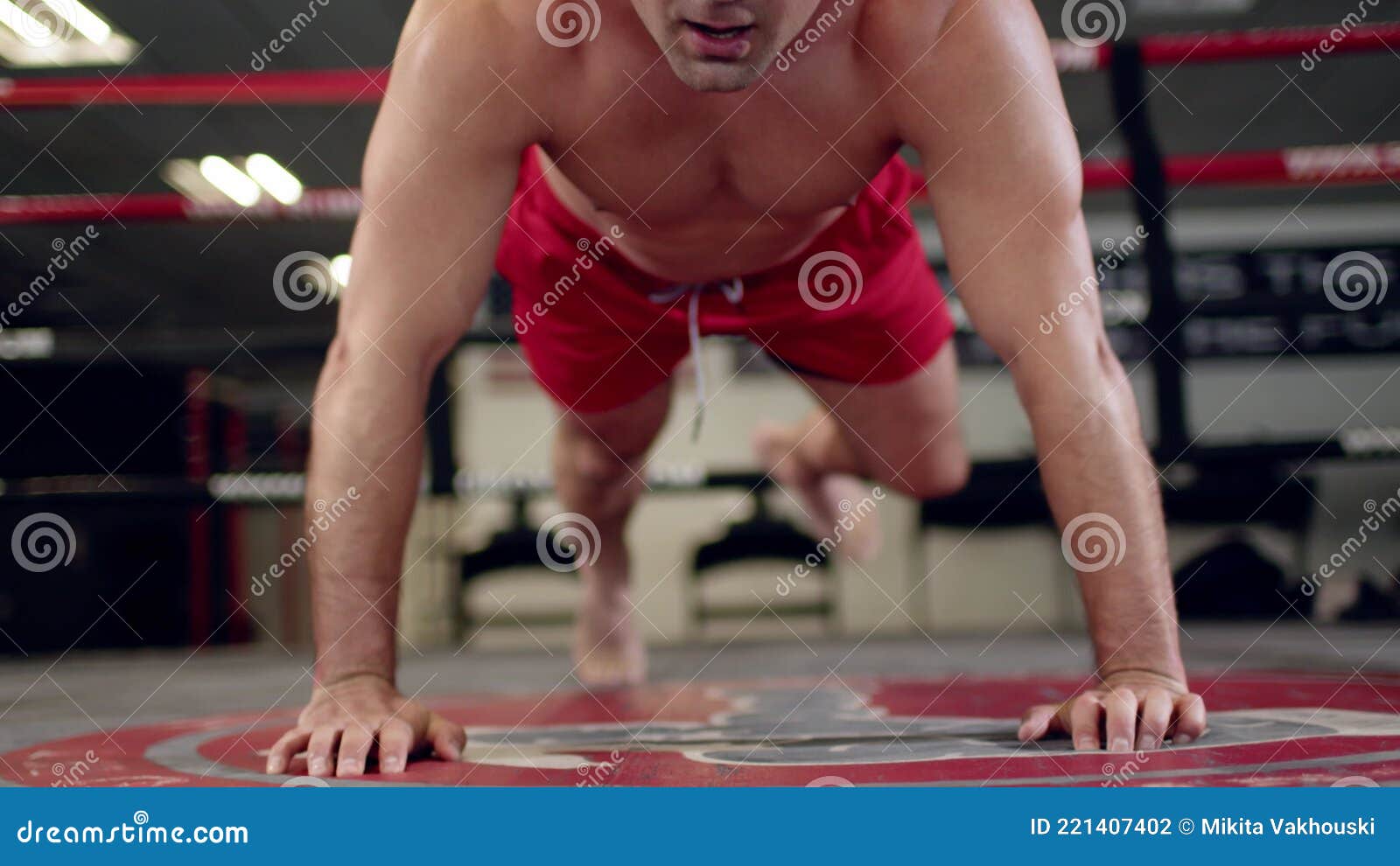 Muscular Shirtless Man Covered in Sweat Does Push-ups in a Gym. Stock ...