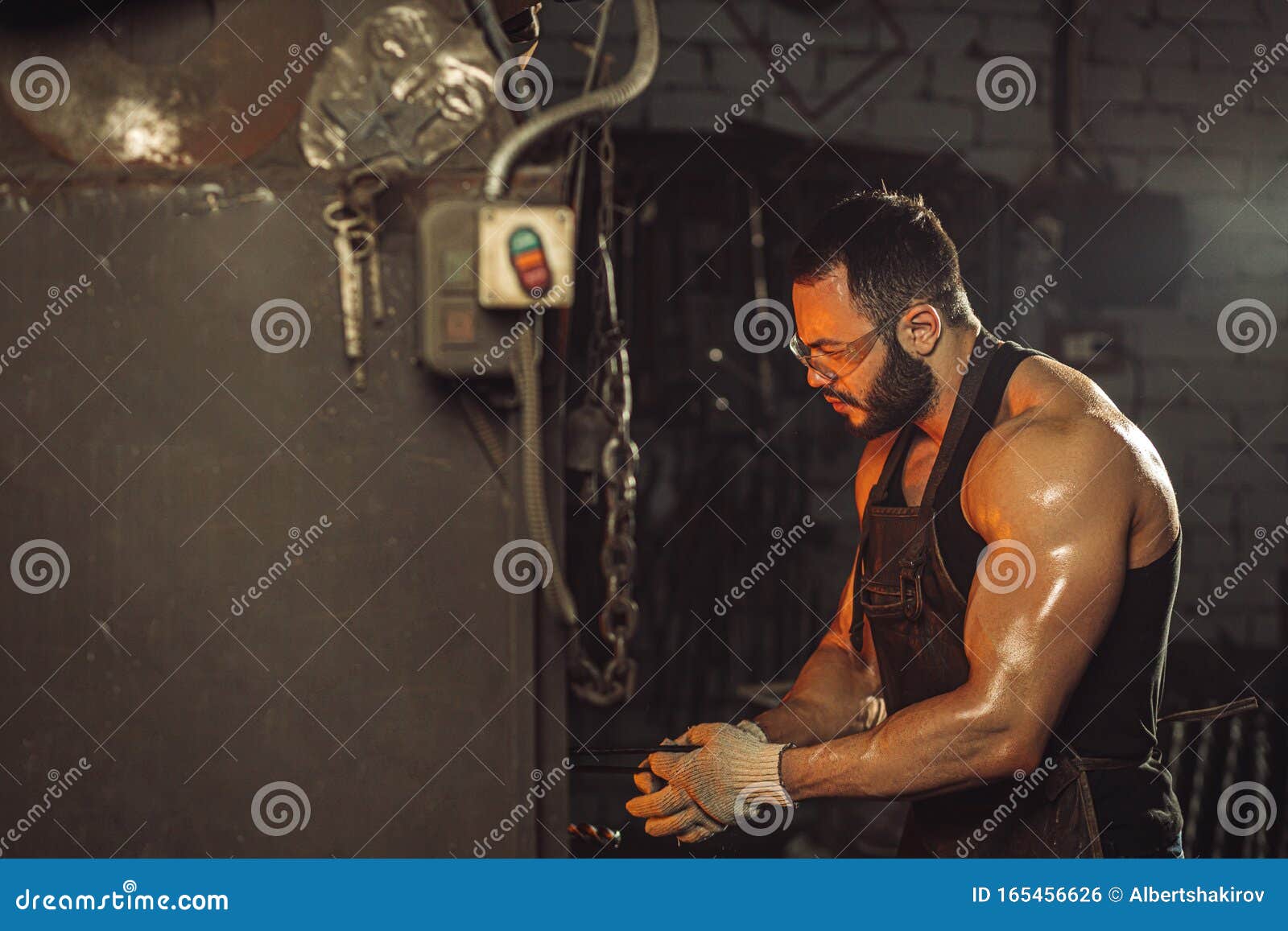Muscular Young Blacksmith in Leather Uniform Stock Photo - Image of ...