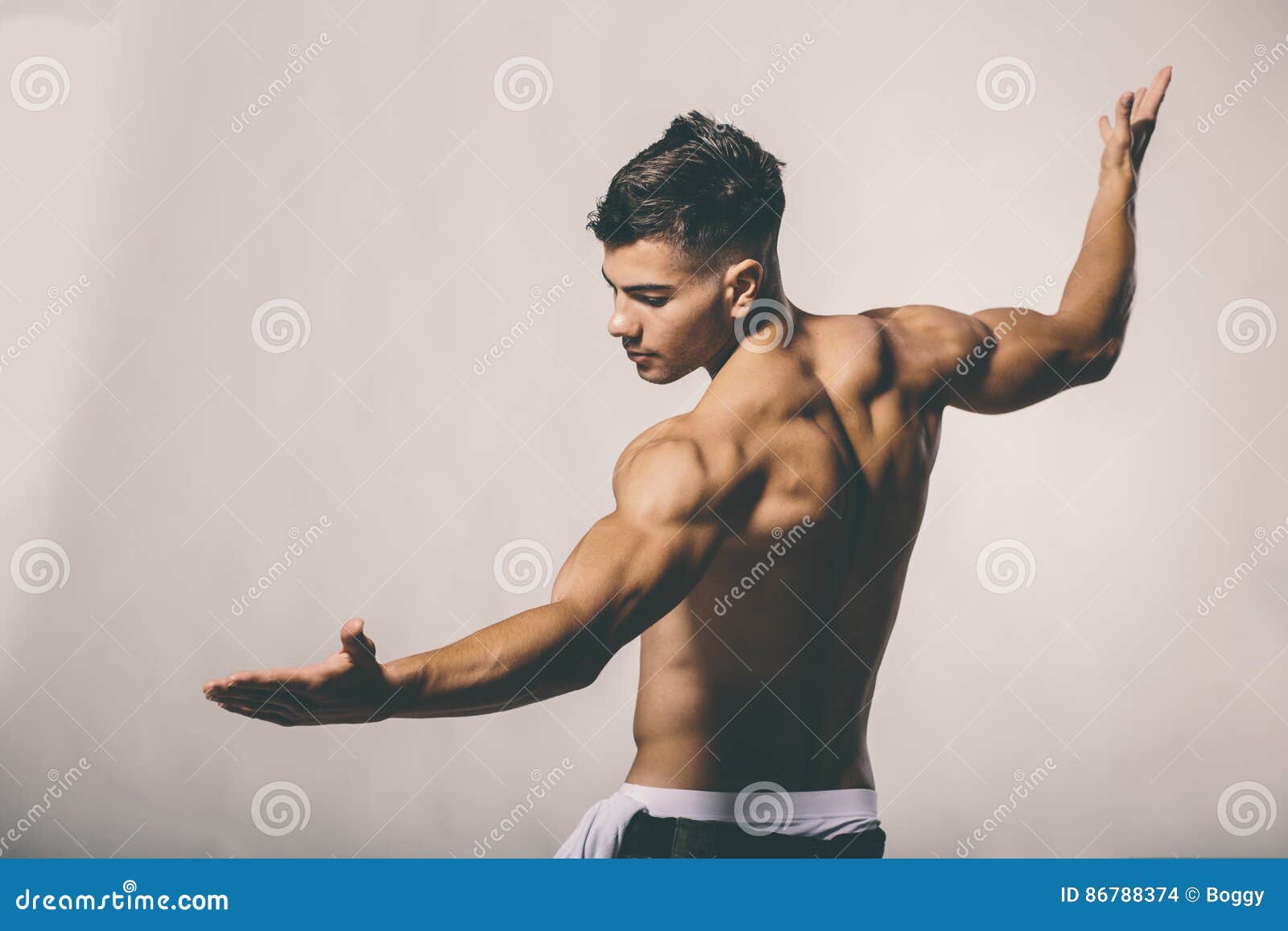 Muscular Young Man Posing in the Studio Stock Photo - Image of posing ...