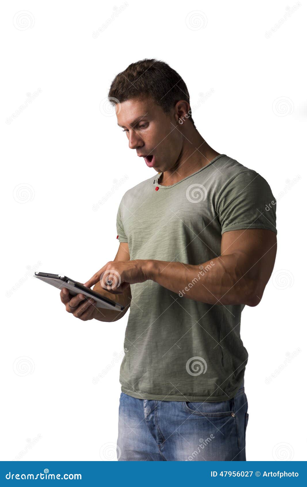 Muscular Young Man Standing Reading from E-book Device with Surprised ...