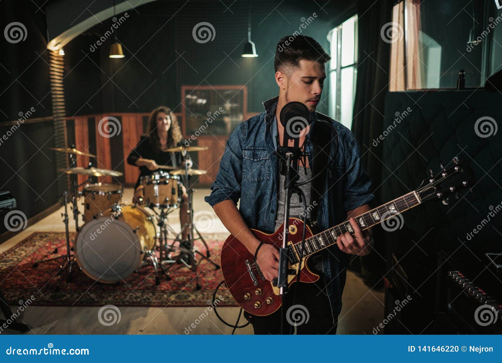 Music Band Having Rehearsal in a Studio Stock Photo - Image of ...