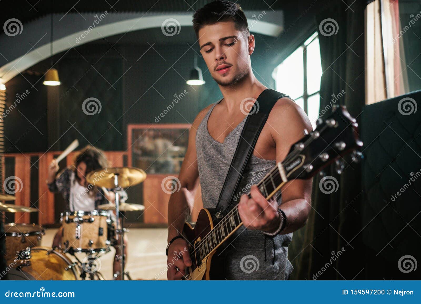 Music Band Having Rehearsal in a Studio Stock Photo - Image of ...