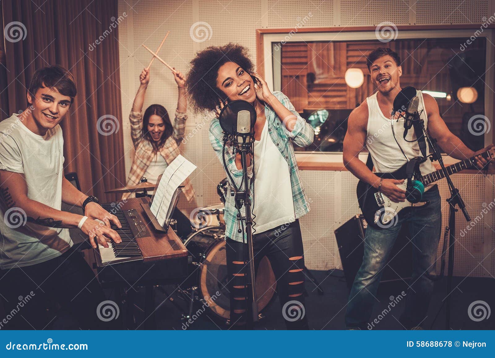 Music Band Performing in a Studio Stock Photo - Image of microphone ...
