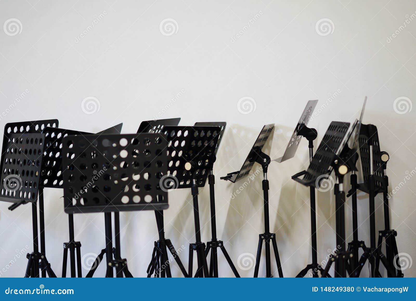 Music Note Stands on Floor Near White Wall Stock Photo - Image of light ...