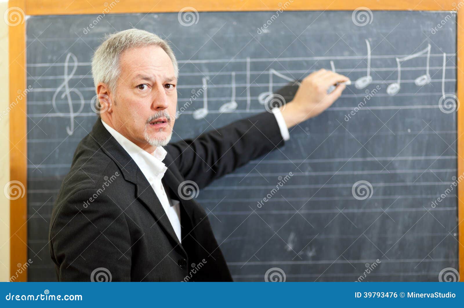 Music Teacher Writing Notes On A Blackboard Stock Photo - Image: 39793476