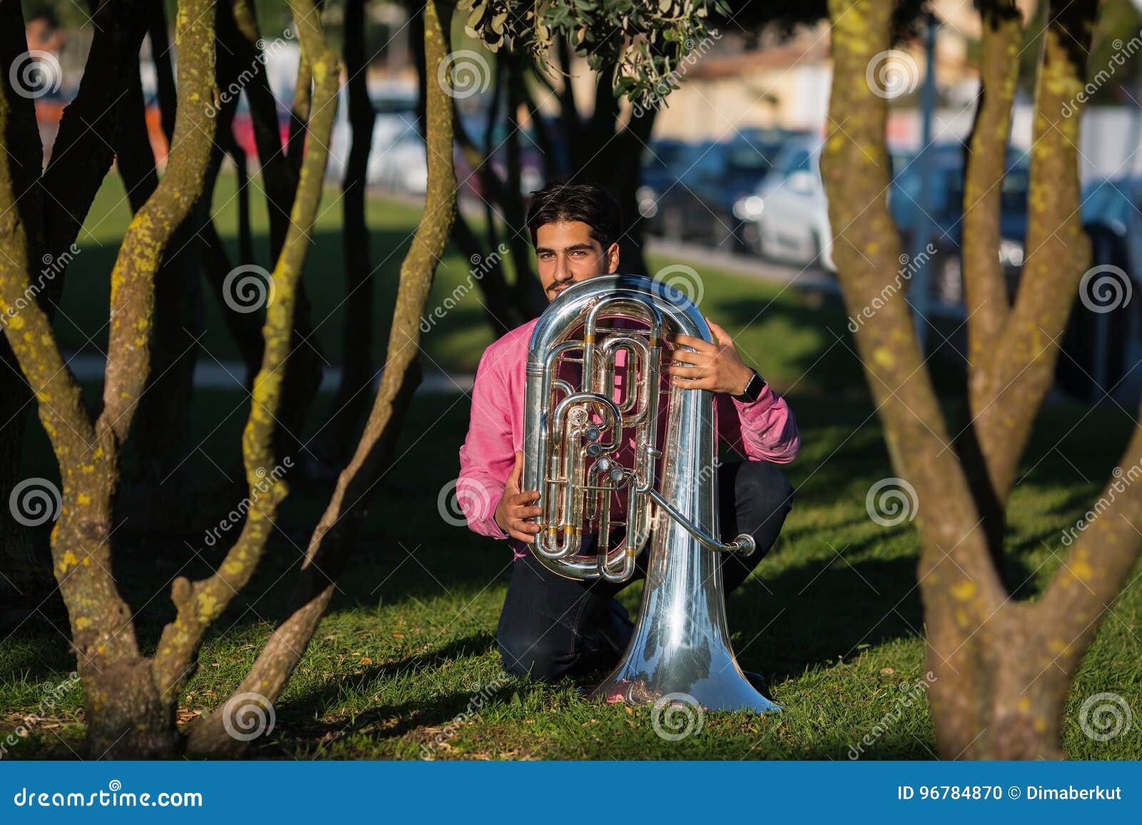 Musician with the Tuba Sitting on the Grass in the Park. Nature. Stock ...