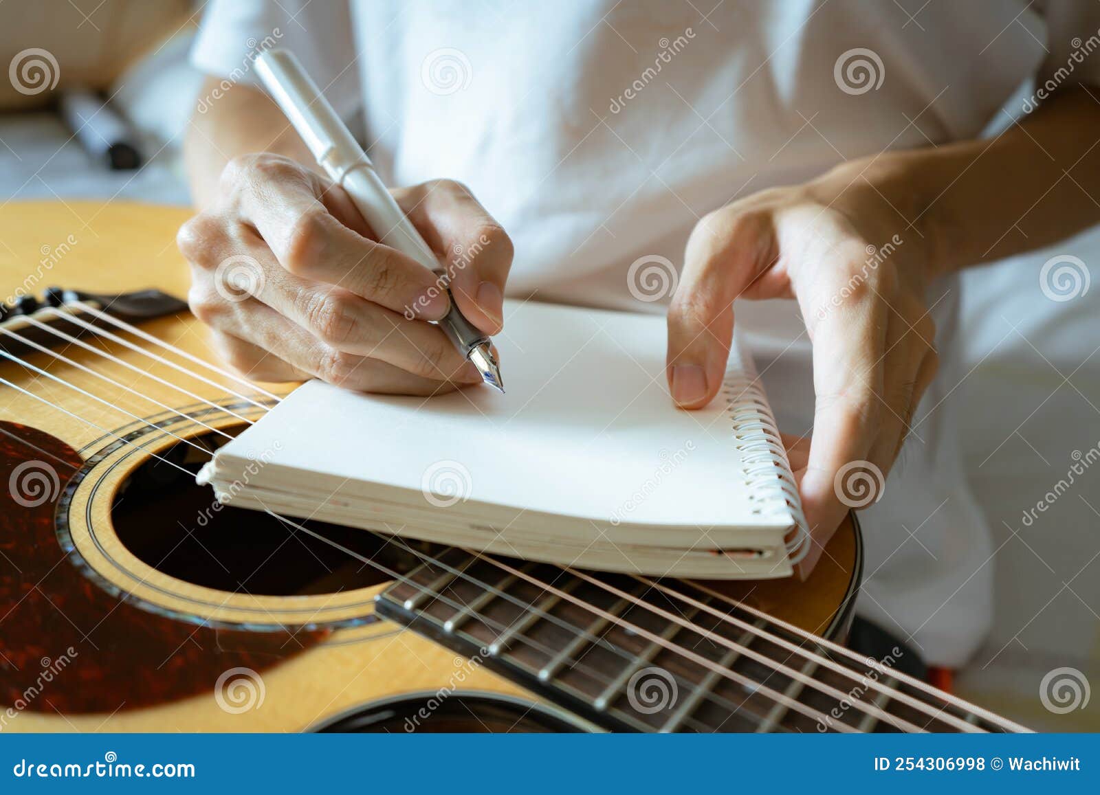 Musician Using Pen and Notebook To Write a Song Stock Photo - Image of ...