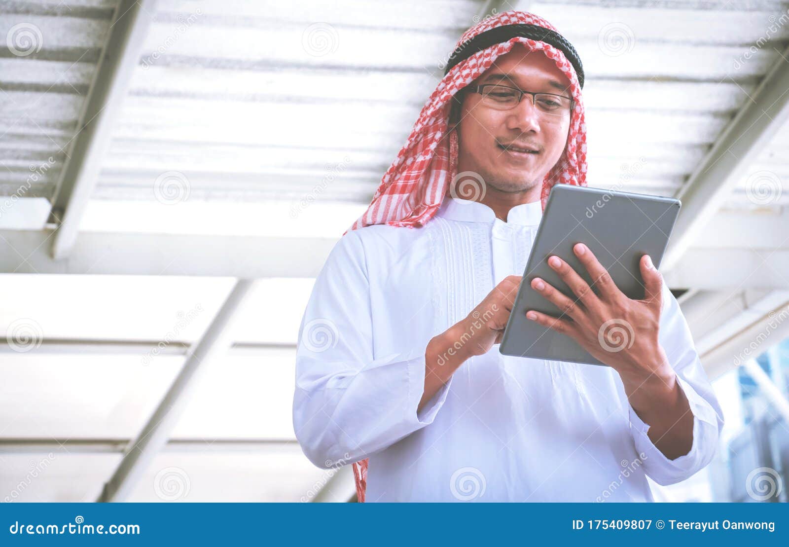 Muslim Arab Man and Smart Phone.he is Using Tablet Pc Computer and ...