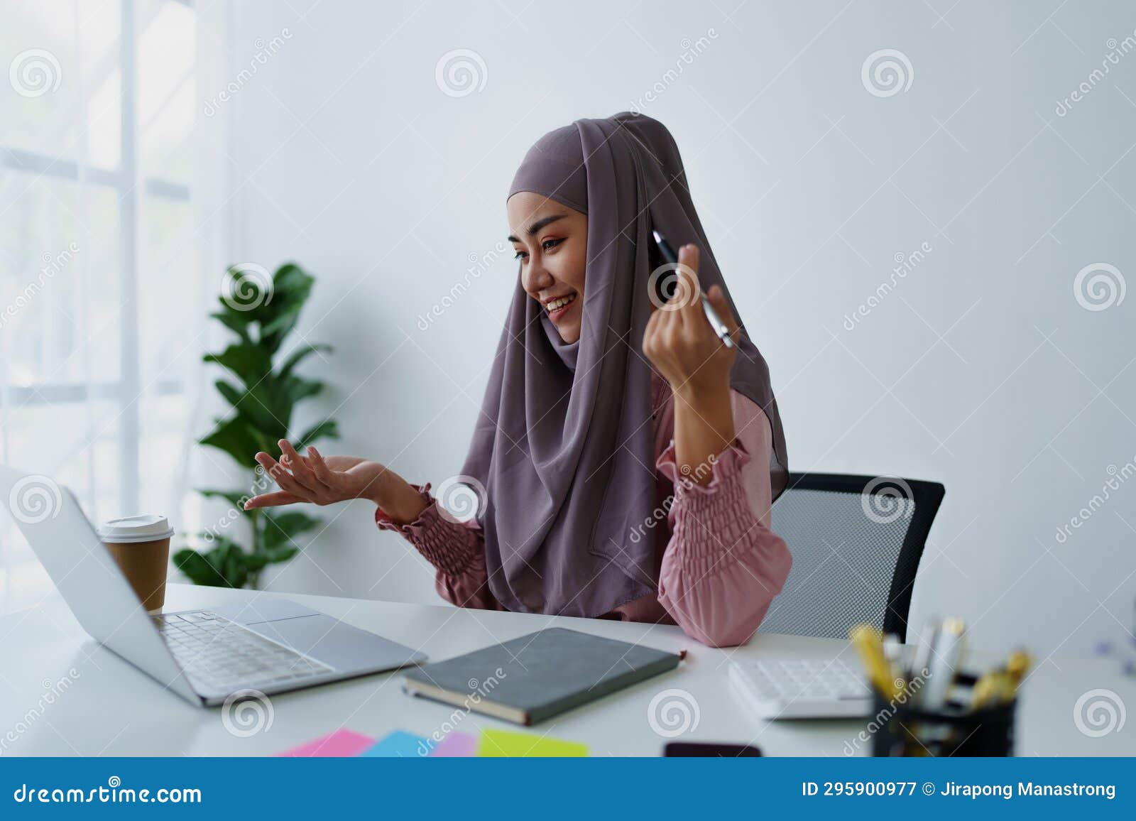 Muslim Female Employee Conferencing Via Computer during Work. Stock ...