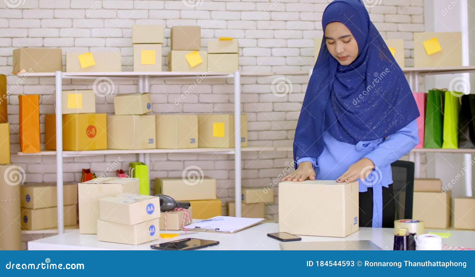 Muslim Female Merchandiser Preparing Parcel at the Office Stock Image ...