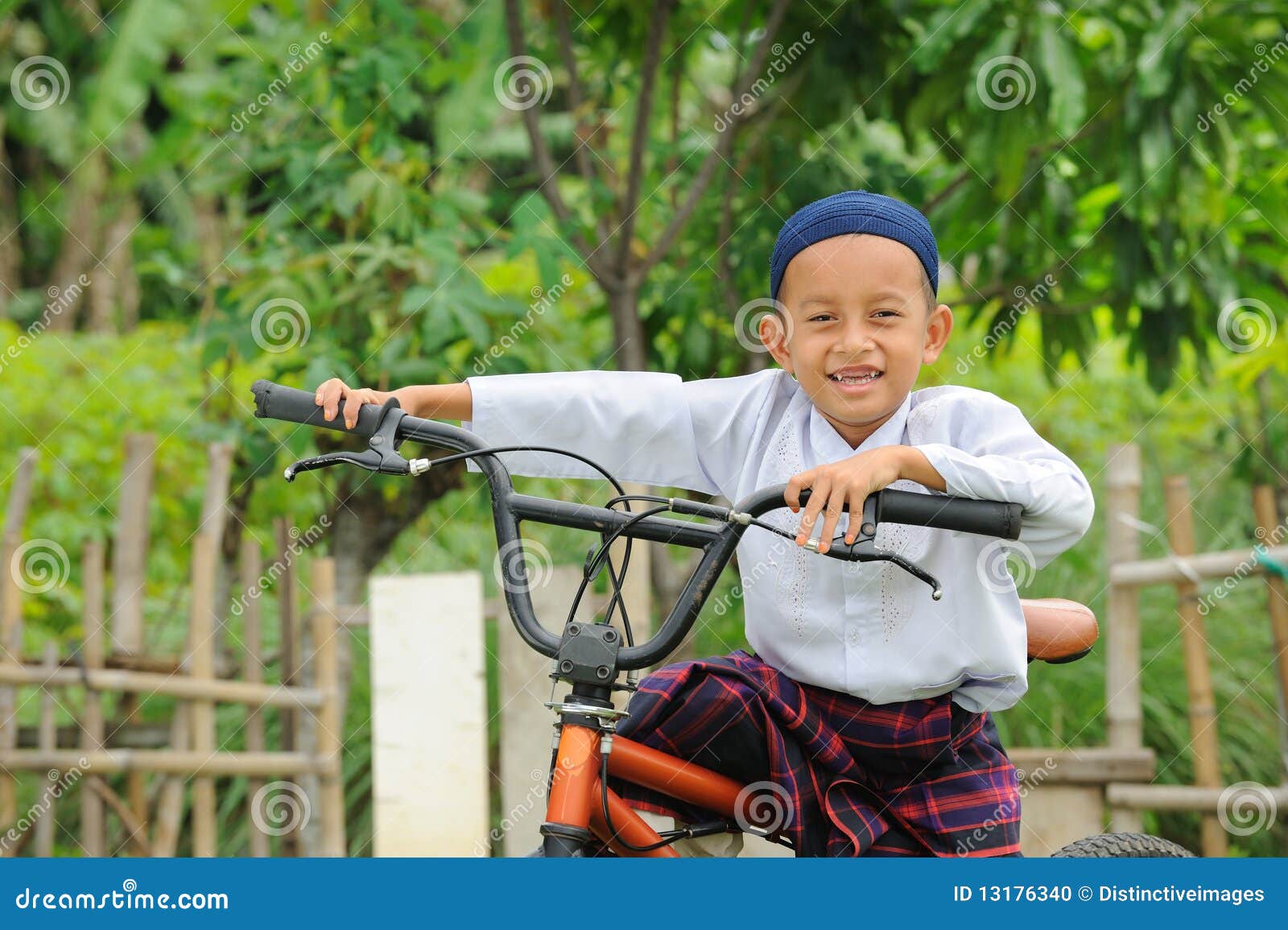 Muslim Kid on Bicycle stock photo. Image of asian, bike - 13176340