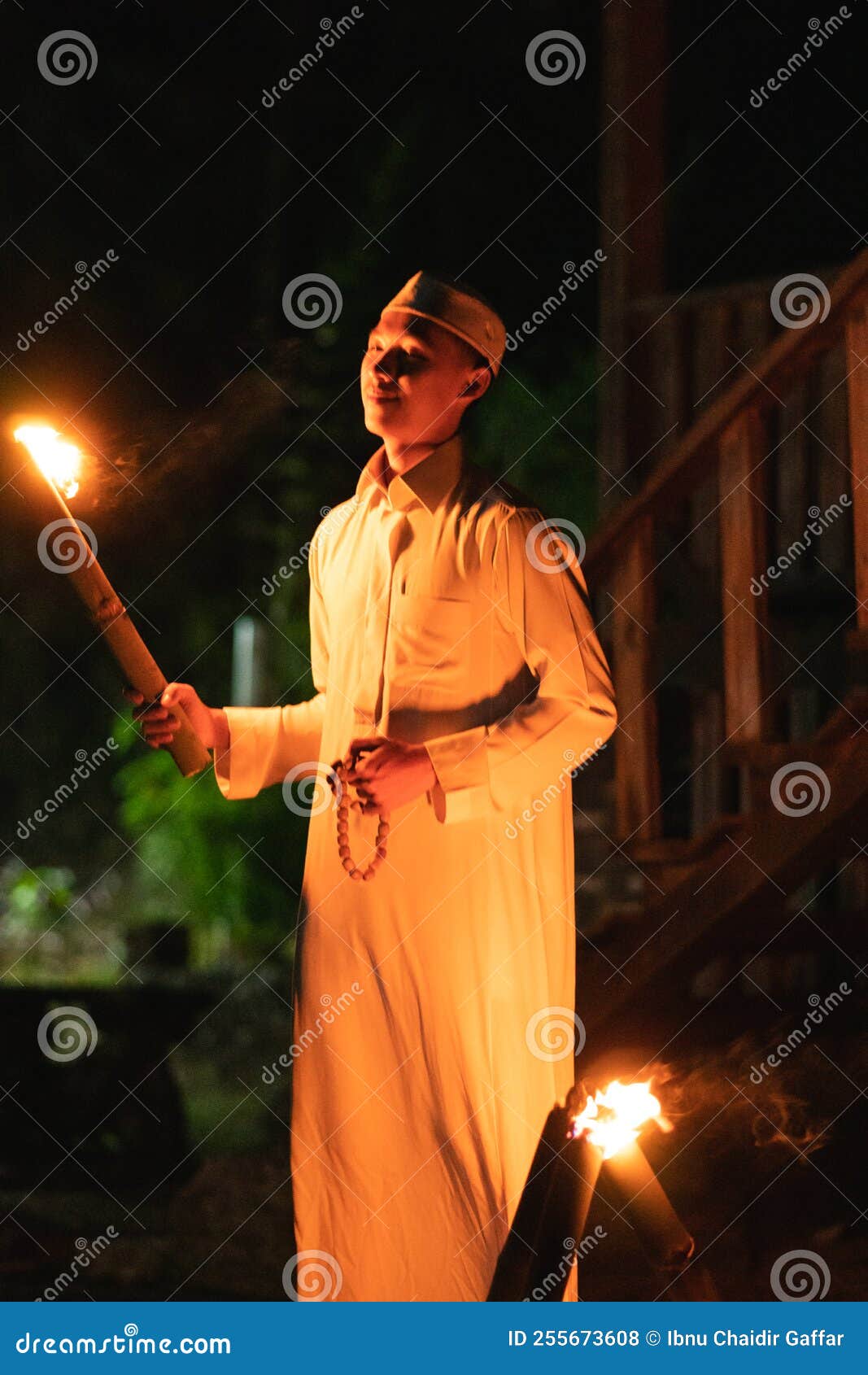 A Muslim Man Standing with the Fire Torch in Her Hand at the Front of ...