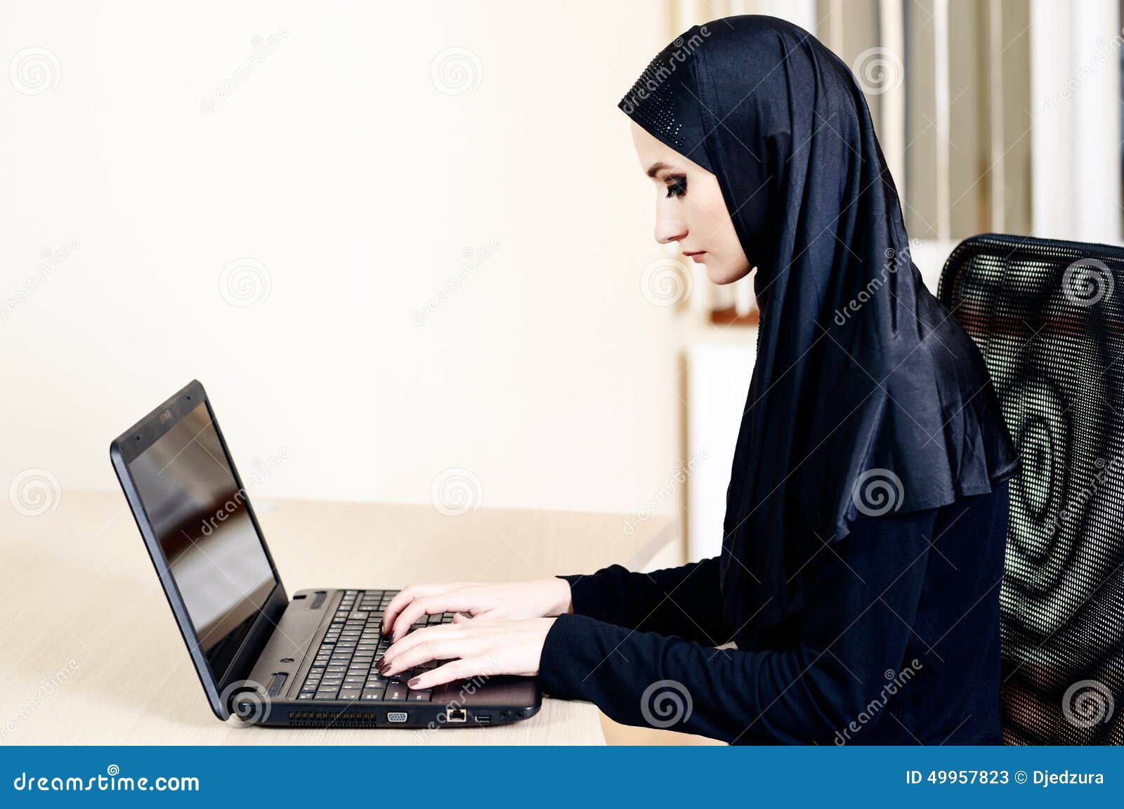Muslim Woman Sitting on an Office Chair and Working on the Computer ...