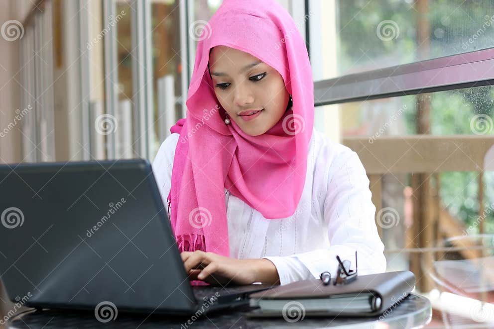 Muslim woman using laptop stock image. Image of muslim - 19726775