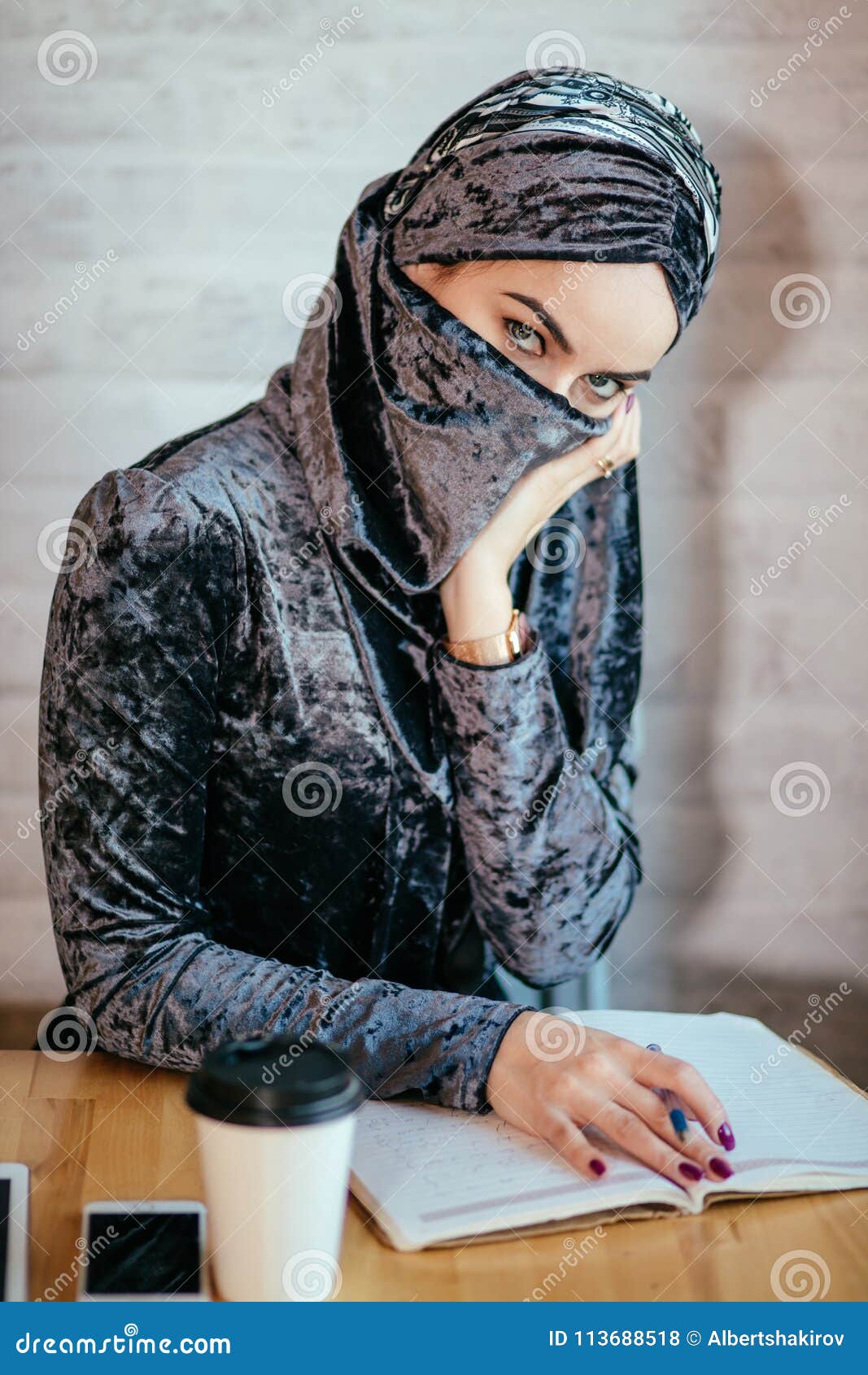 Muslim Woman Writing on Her Notebook in Cafe Stock Photo - Image of ...