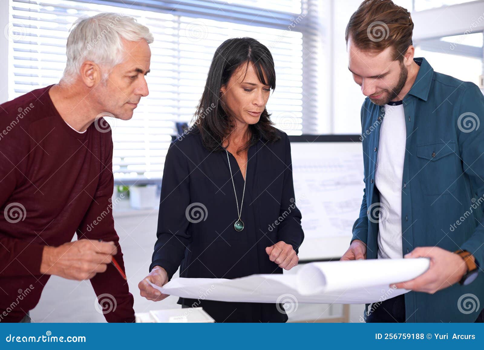 These are My Ideas. a Group of Architects Discussing Building Plans in ...