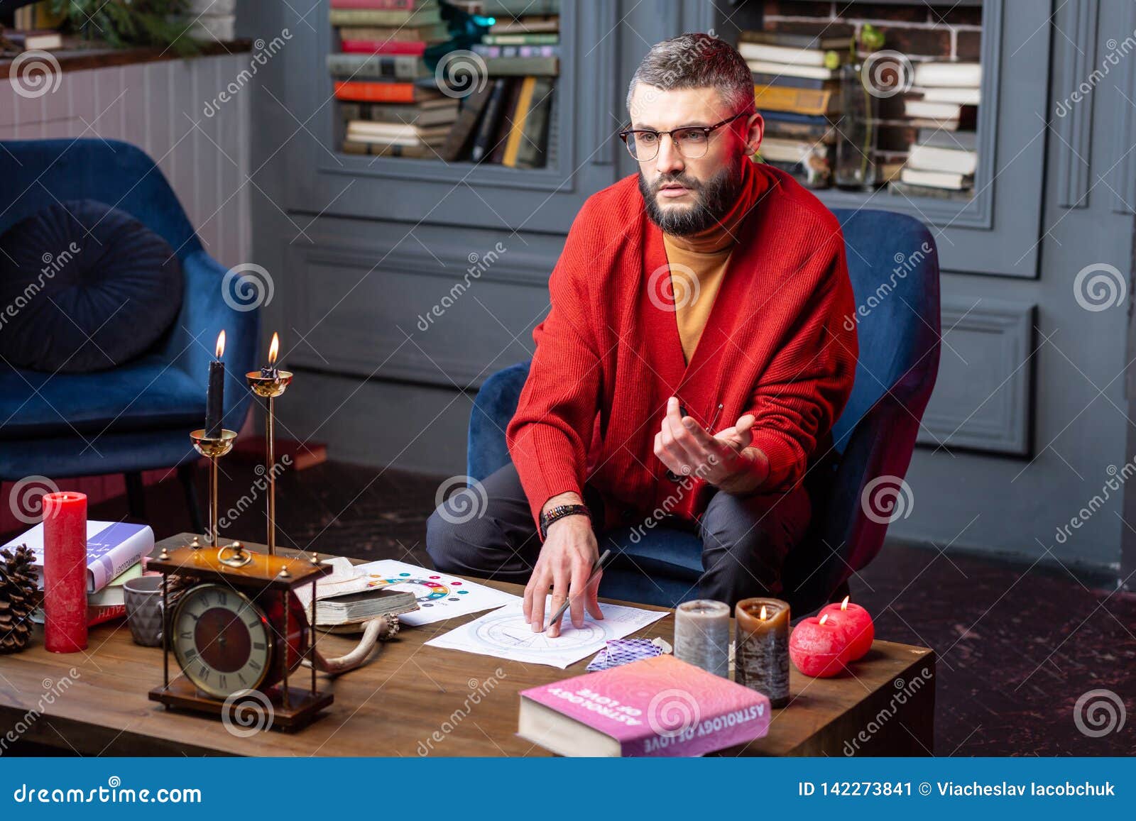 Bearded Astrologist Sitting In Armchair Reading Book And Doing Practice ...