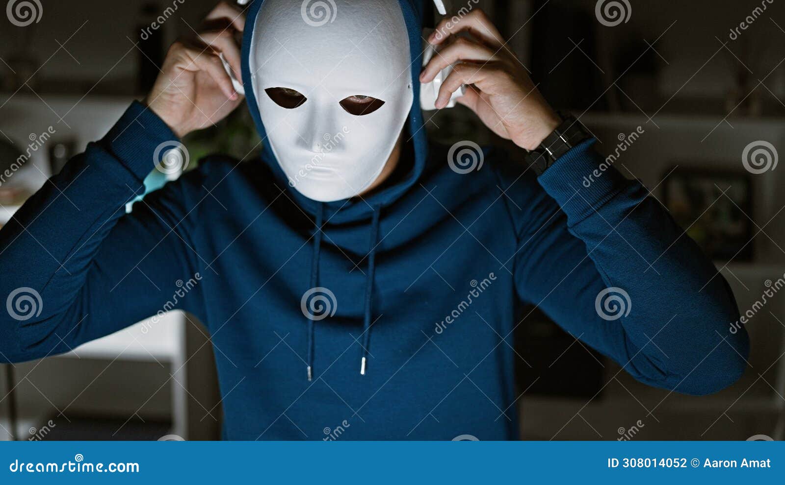 A Mysterious Man Donning a Plain Mask in a Casual Indoor Setting Stock ...
