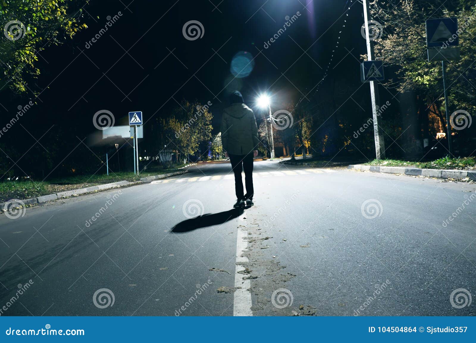 A Mysterious Man Stands Alone in the Street, among Cars in an Empty ... A Mysterious Man Stands Alone in the Street, among Cars in an Empty ...