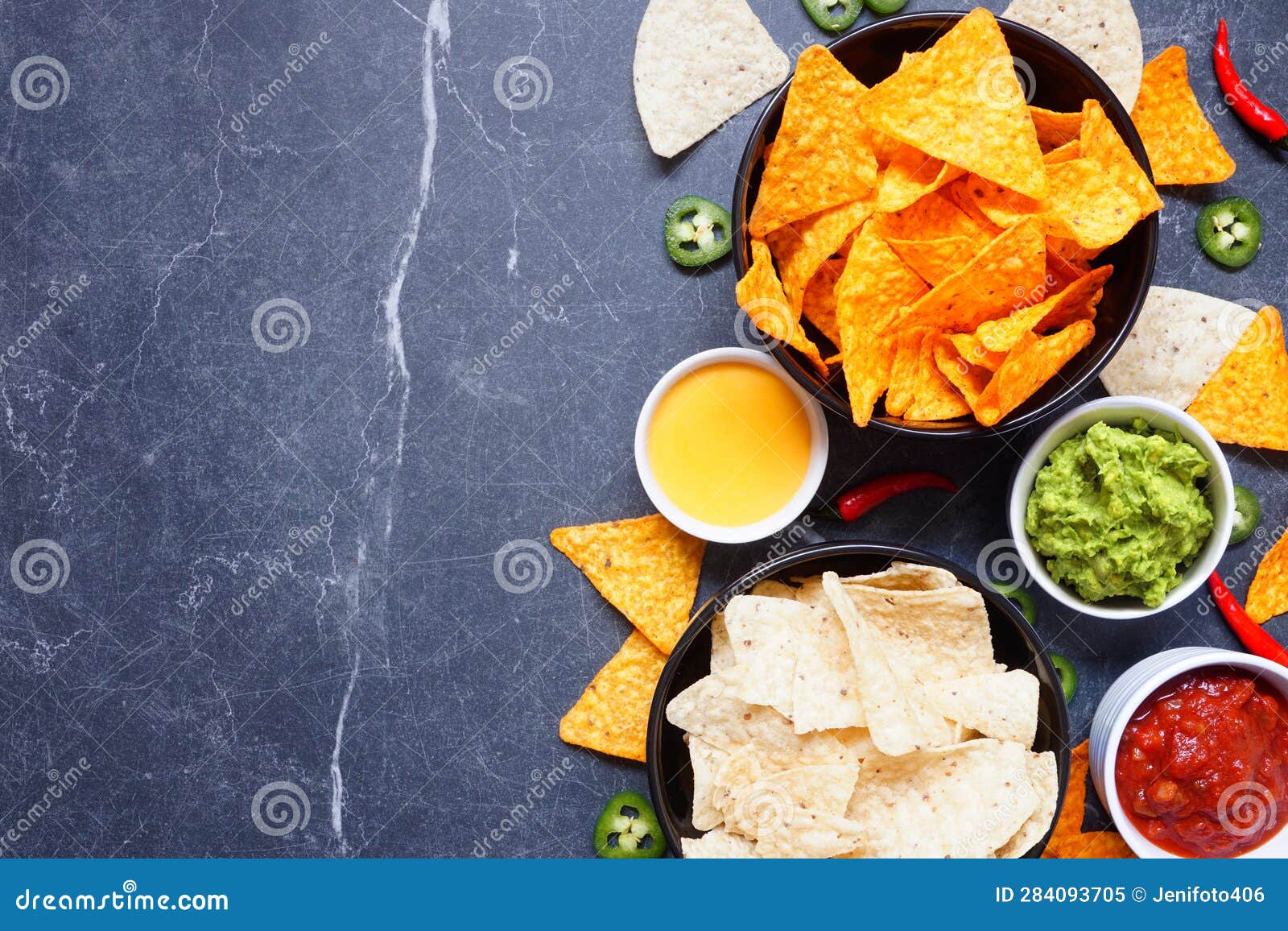 Nachos and Dip Side Border Over a Dark Stone Background Stock Image ...