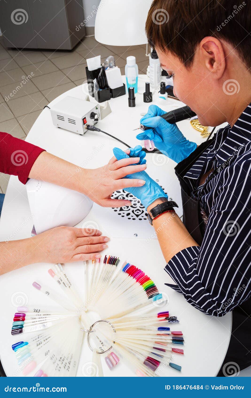 Nail Salon, Hands of Client and Master. Nail Treatment with a Cutter ...