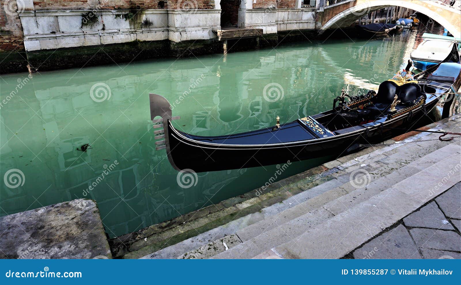 In The Narrow Canal Of Venice There Is A Gondola Waiting For The Next